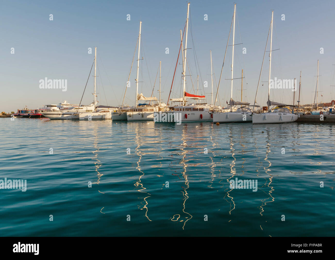 Sea bay with yachts at sunset Stock Photo - Alamy