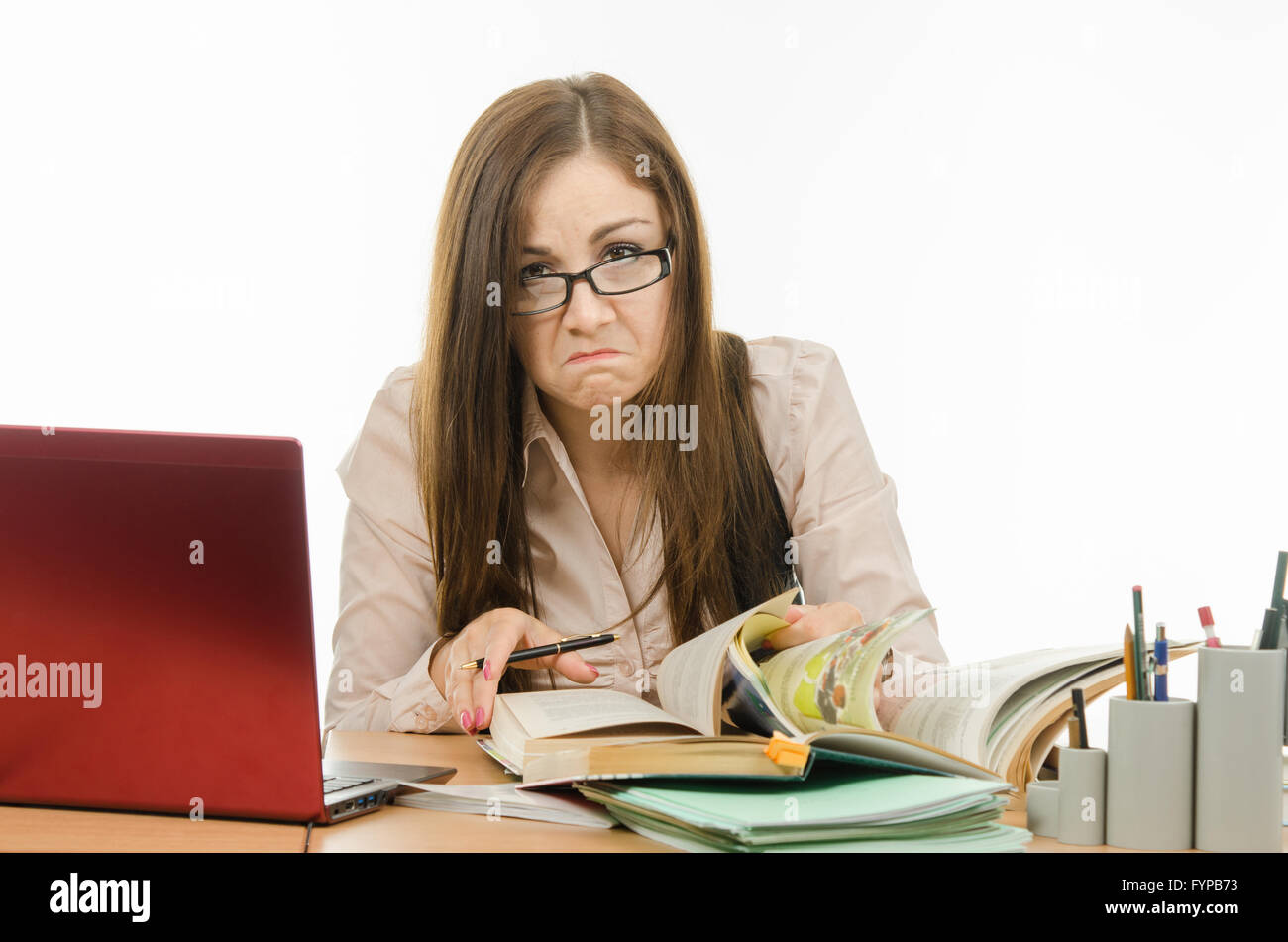 Frustrated teacher is looking for something in a book Stock Photo - Alamy