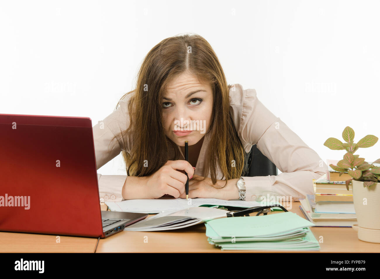Very tired teacher checks homework Stock Photo - Alamy