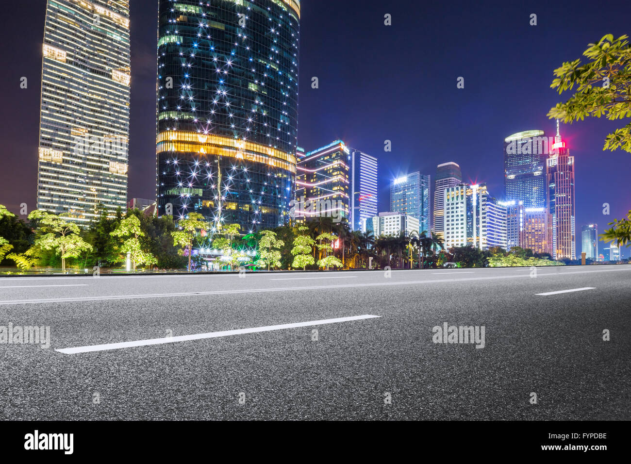 asphalt road near skyscrapers at night Stock Photo - Alamy