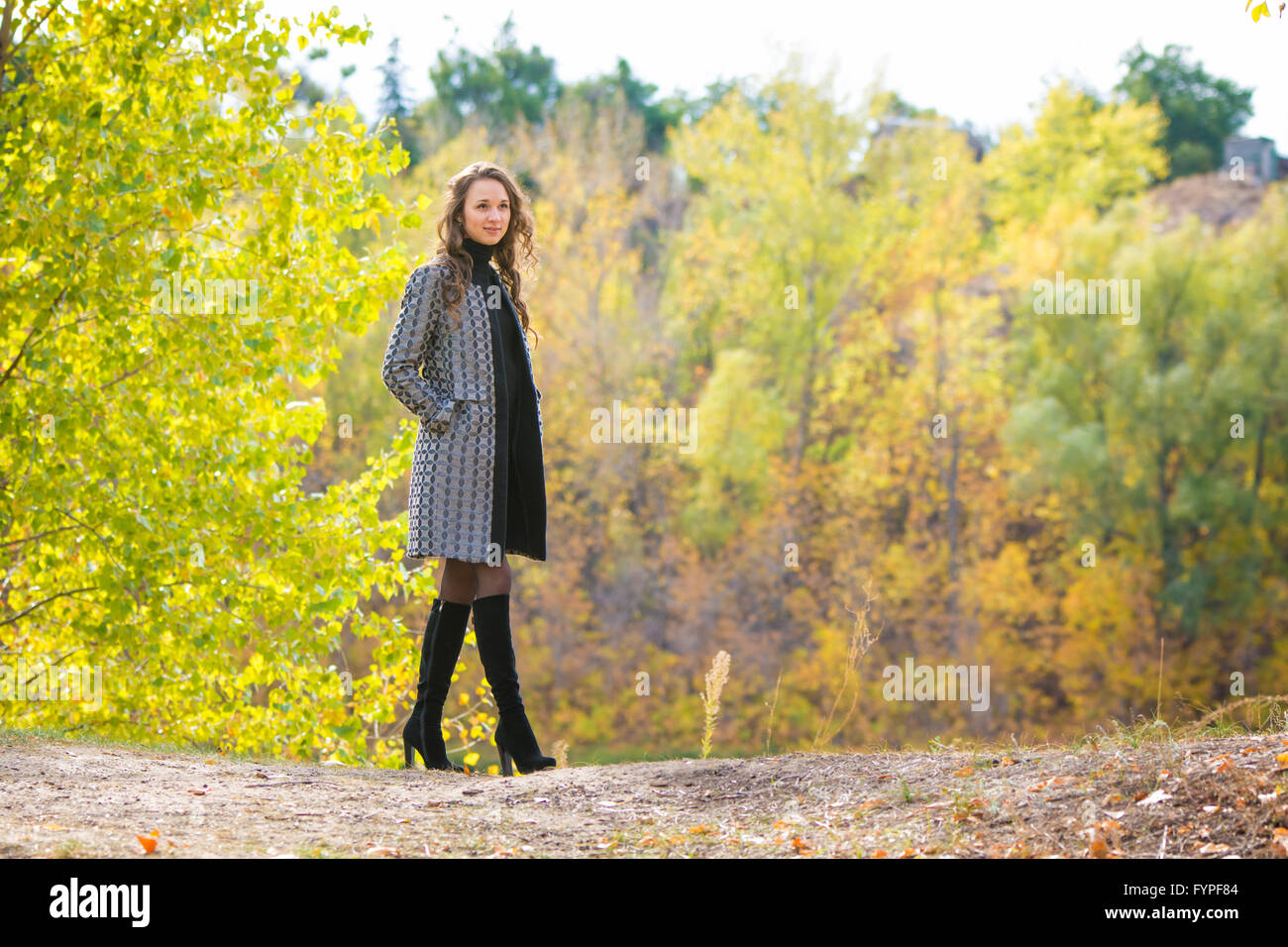 Young girl walking in the autumn forest Stock Photo - Alamy