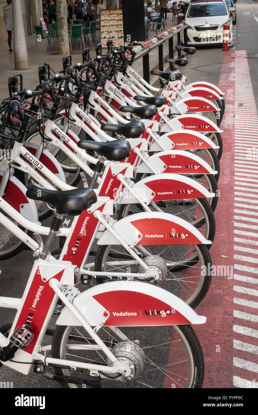 Row of bright red and white bikes in Barcelona Stock Photo - Alamy