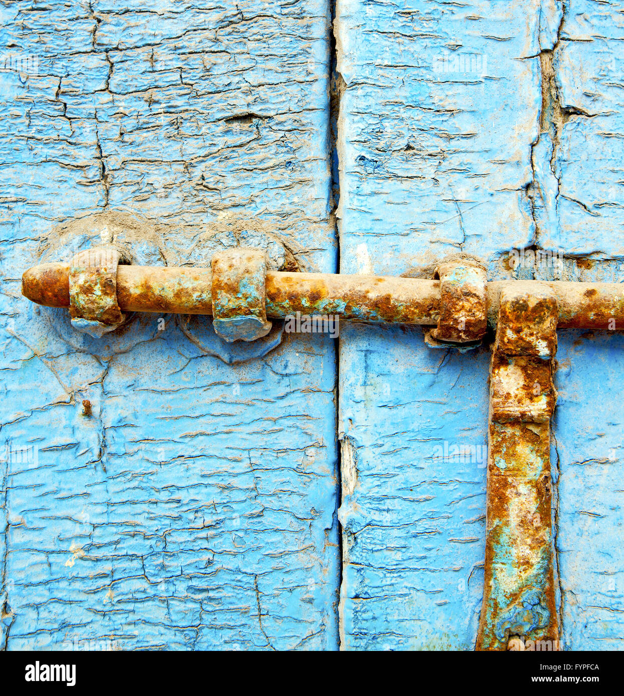 rusty metal nail dirty stripped paint in the blue wood door and morocco ...