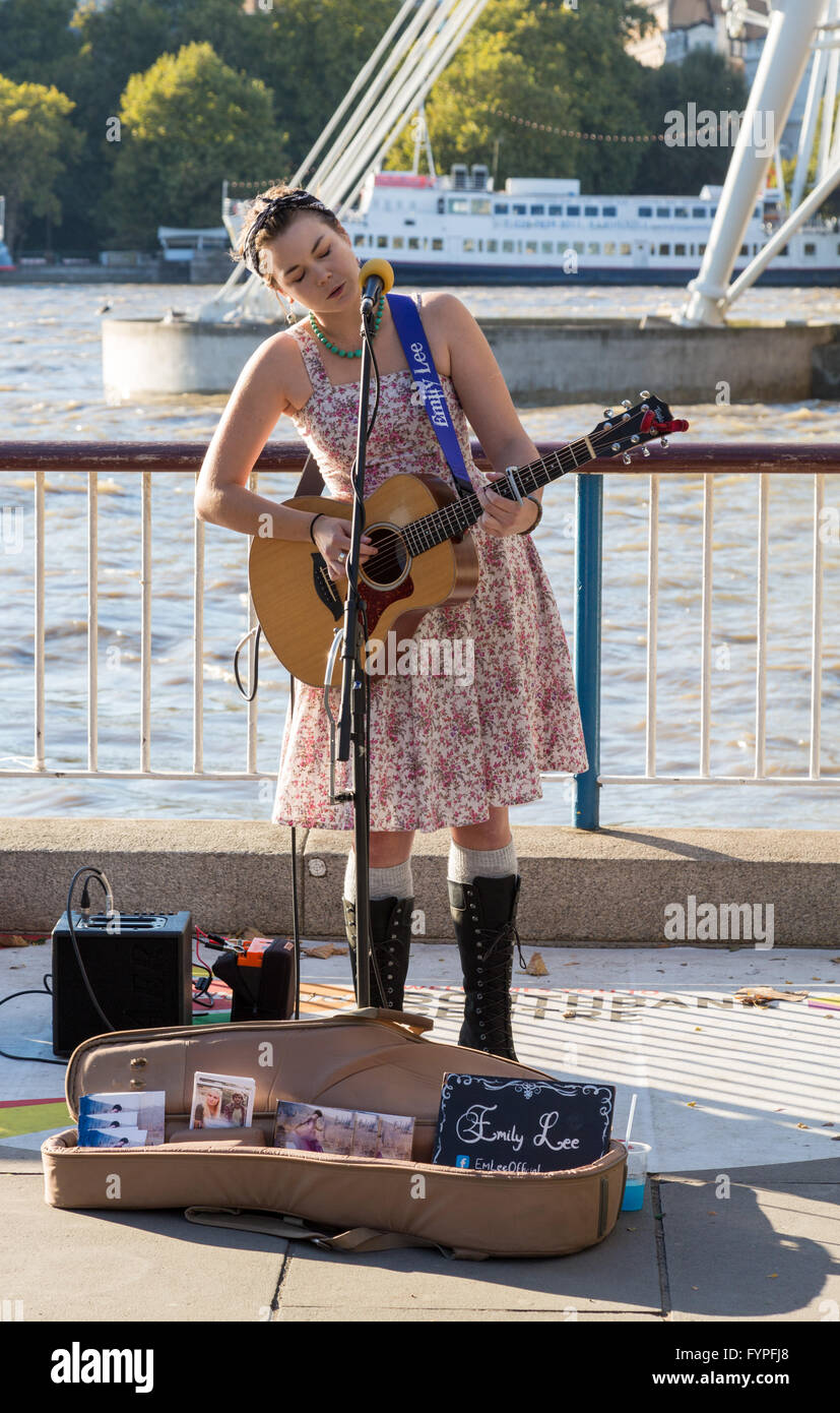 Emily Lee singing with guitar by River Thames Stock Photo - Alamy