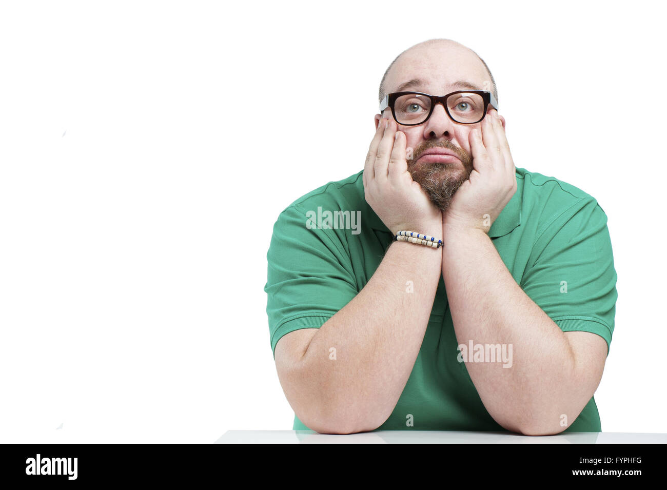 Sad man sitting at the table Stock Photo - Alamy