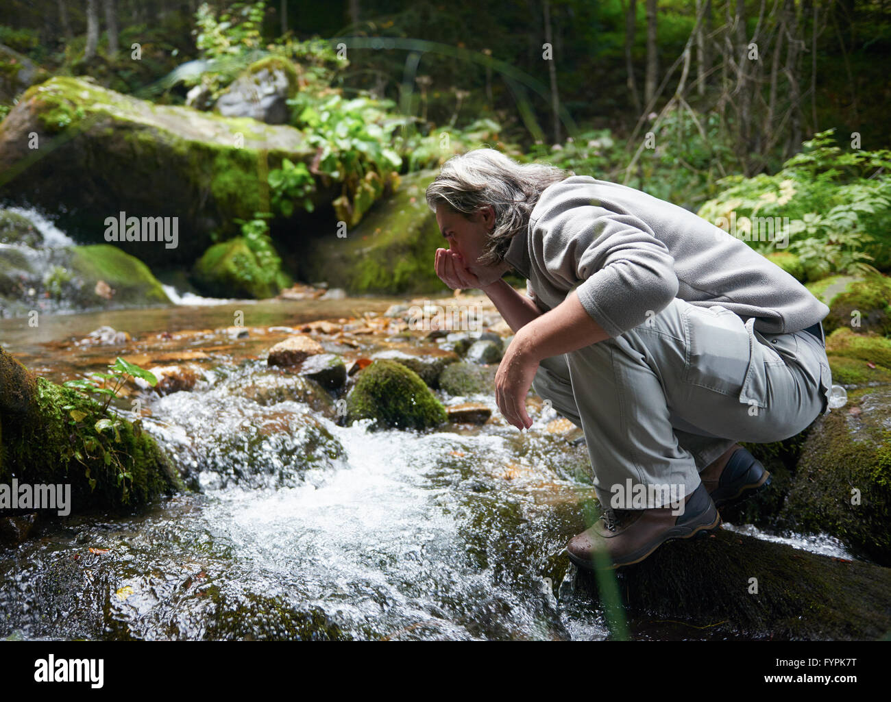 man drinking fresh water from spring Stock Photo - Alamy