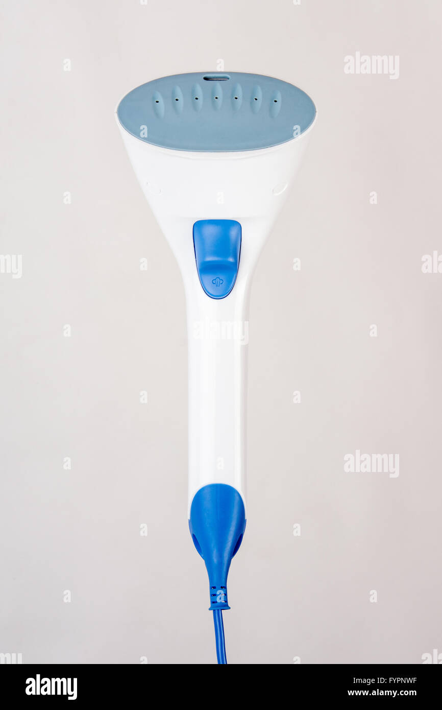 Hand household steamer on a light background Stock Photo - Alamy