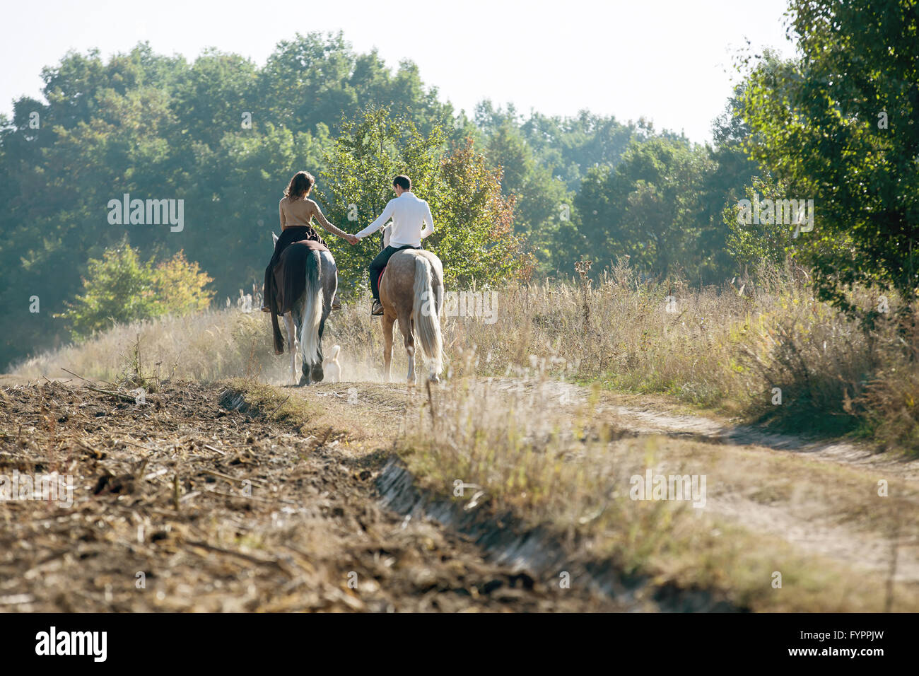 Young couple in love riding a horse Stock Photo - Alamy