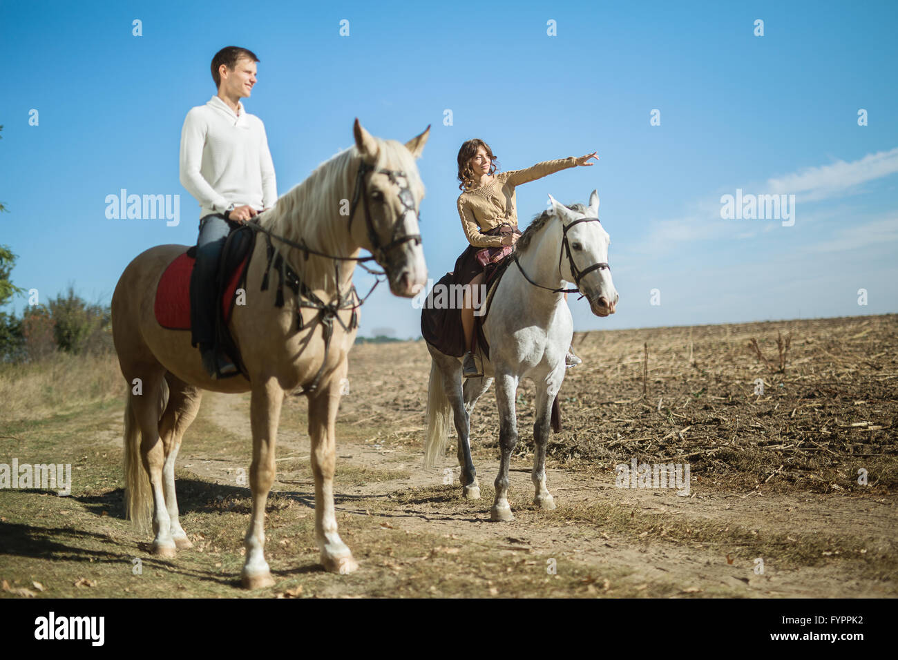Young couple in love riding a horse Stock Photo - Alamy