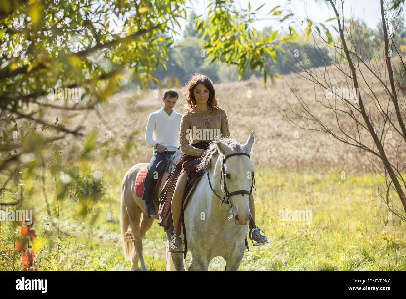 Young couple in love riding a horse Stock Photo - Alamy