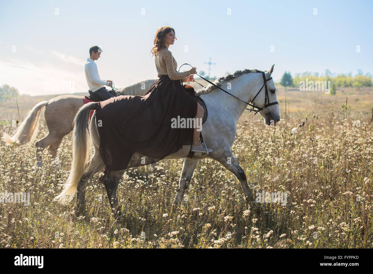 Young couple in love riding a horse Stock Photo - Alamy