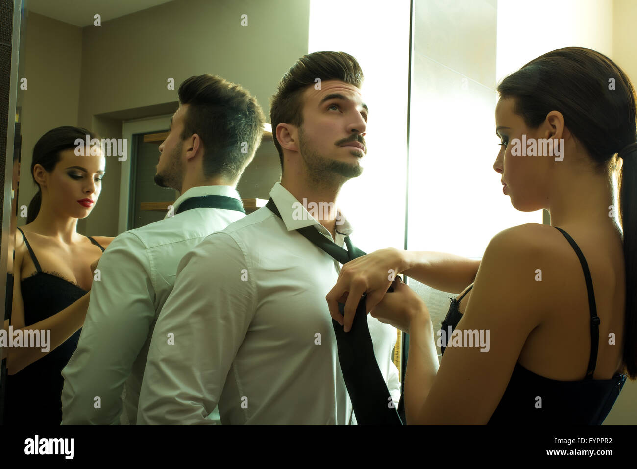 A young couple getting dressed in the changing room Stock Photo - Alamy