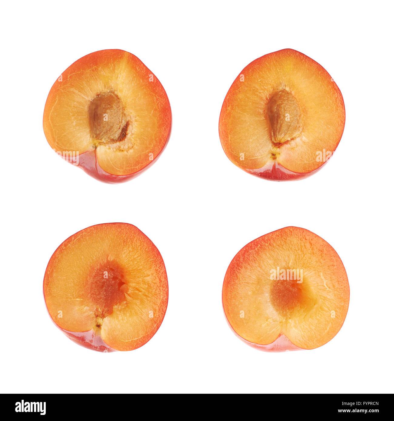 Cut open plum half isolated Stock Photo - Alamy