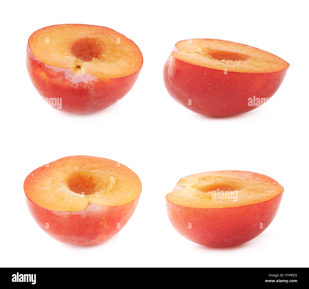 Cut open plum half isolated Stock Photo - Alamy