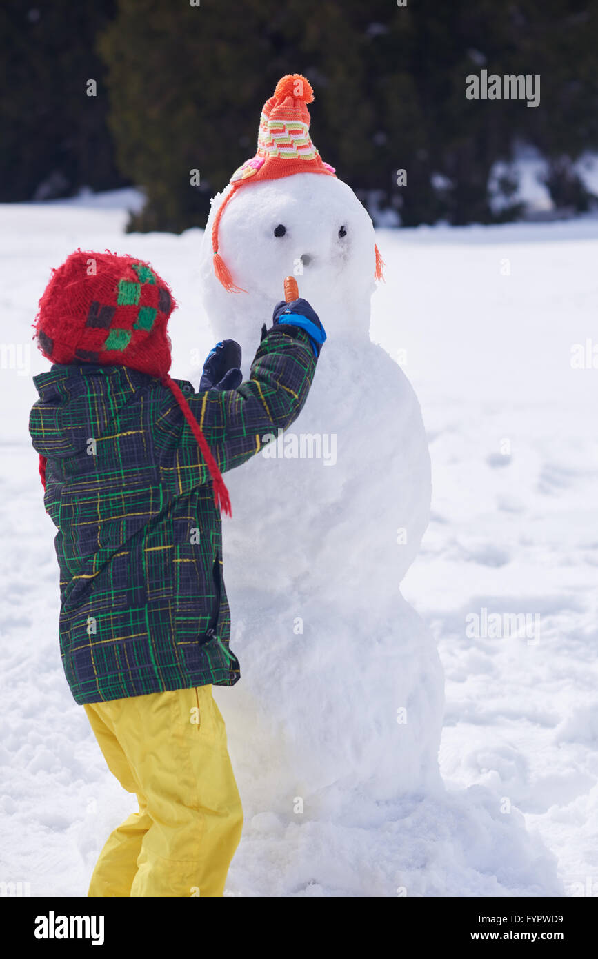 boy making snowman Stock Photo - Alamy