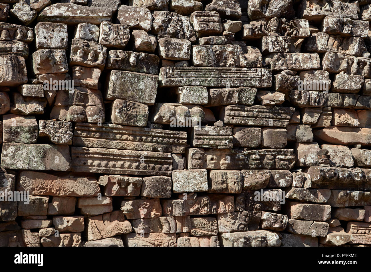 Stack of fallen stone pieces from Bayon temple ruins, Angkor Thom ...