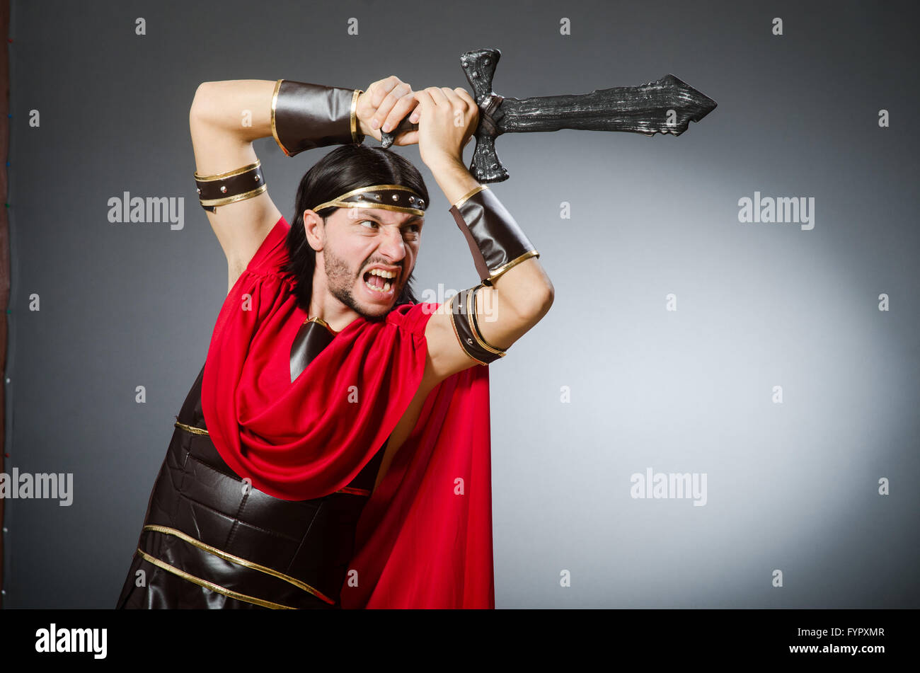 The roman warrior with sword against background Stock Photo - Alamy