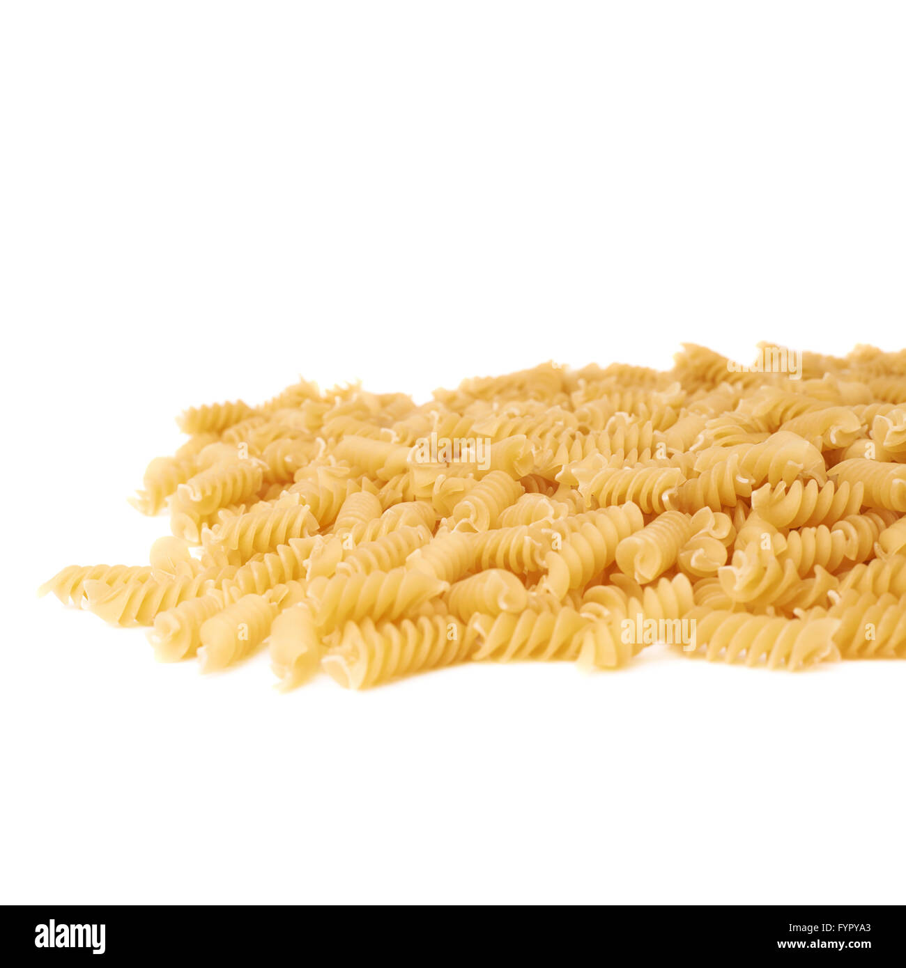 Pile of dry rotini pasta over isolated white background Stock Photo - Alamy