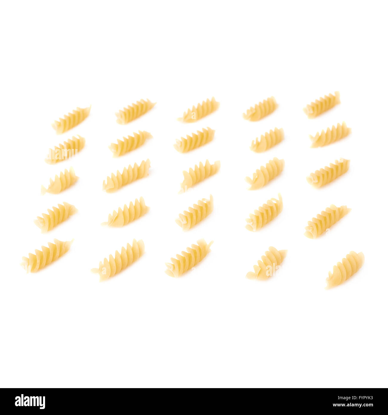 Single pieces of dry rotini pasta over isolated white background Stock ...