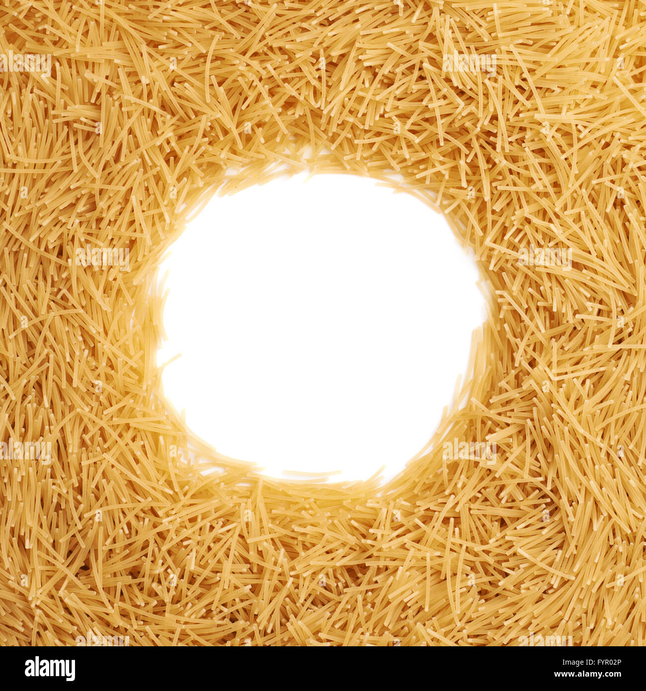 Round frame made of dry noodles pasta over isolated white background ...