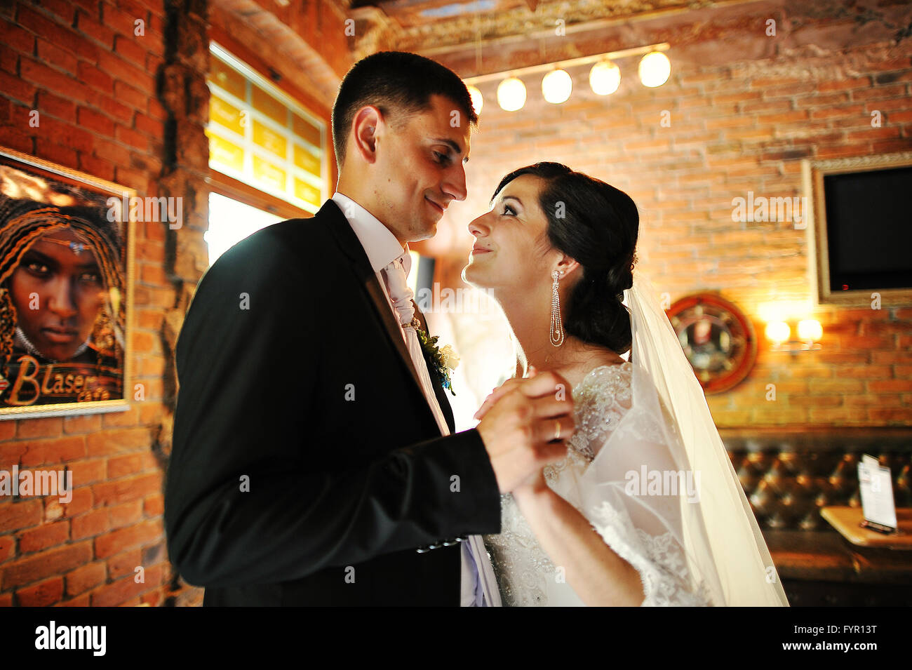 Smiling cute bride looking at her groom Stock Photo - Alamy
