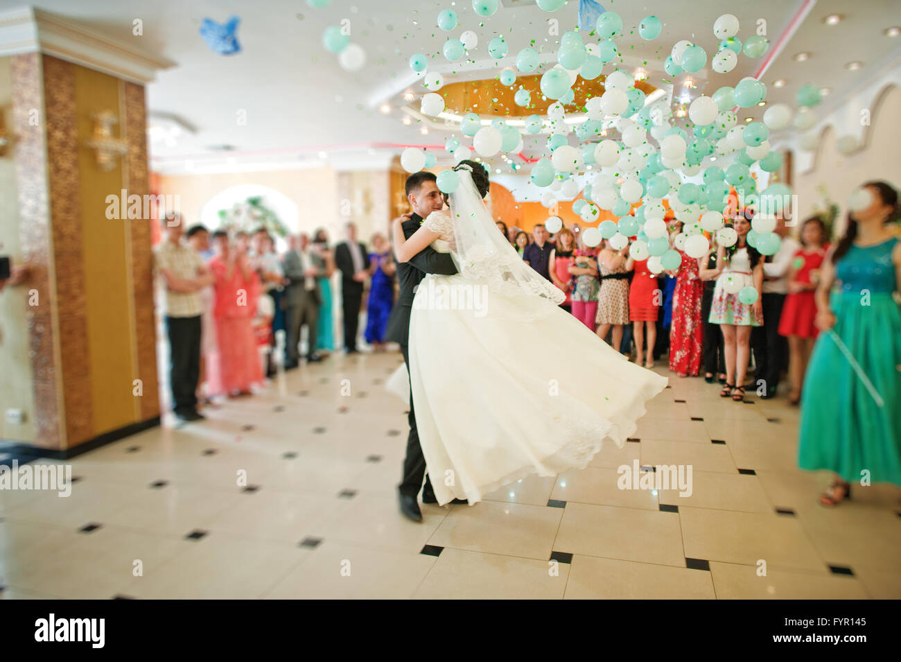 First wedding dance with falling balloons Stock Photo - Alamy