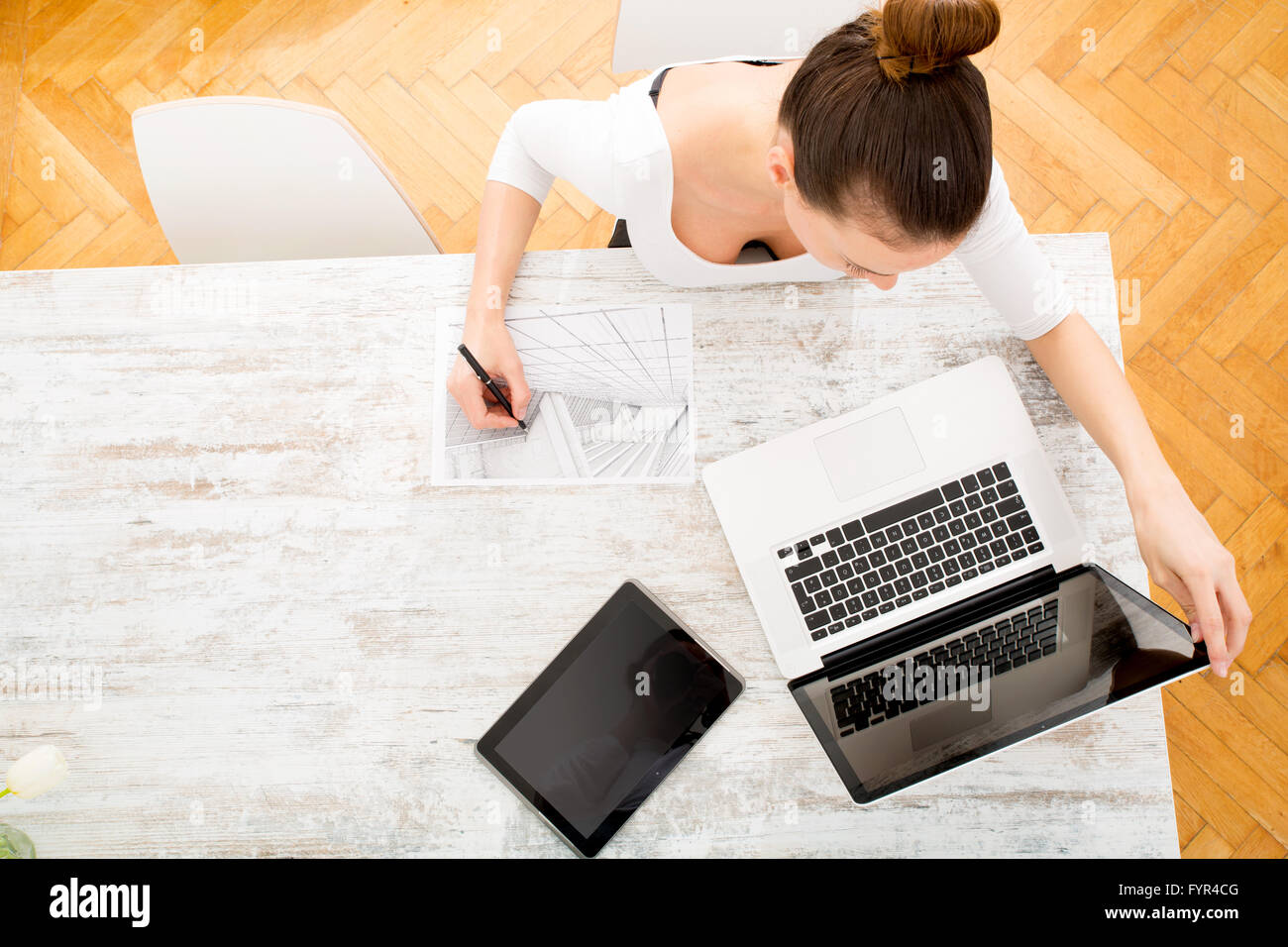 Woman drawing a blueprint Stock Photo - Alamy