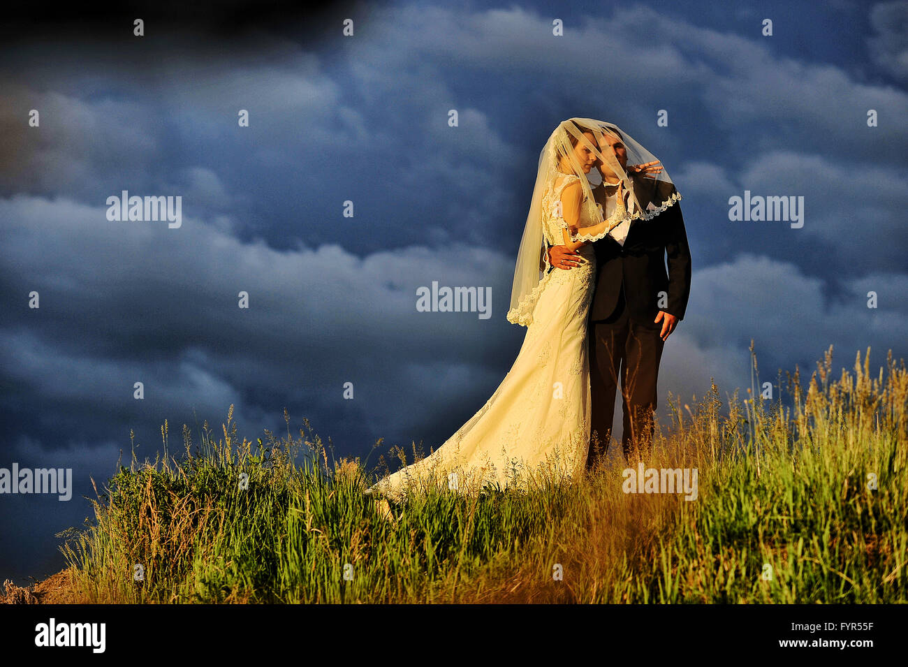 Cloudy sky and wedding couple Stock Photo - Alamy