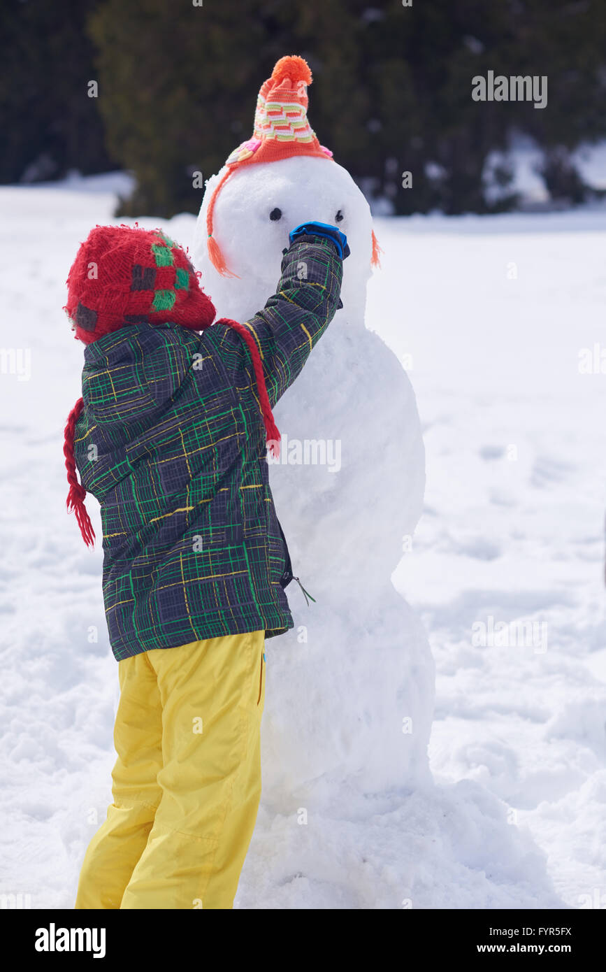 boy making snowman Stock Photo - Alamy