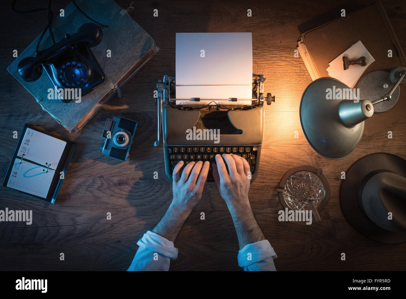 Vintage journalist's desk 1950s style, he is working and typing on his ...