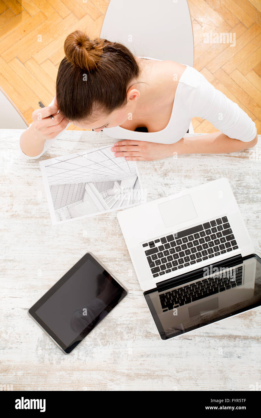 Woman drawing a blueprint Stock Photo - Alamy