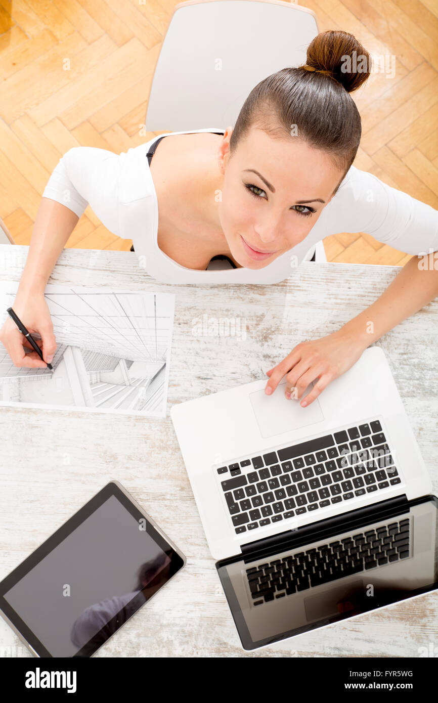 Woman drawing a blueprint Stock Photo - Alamy