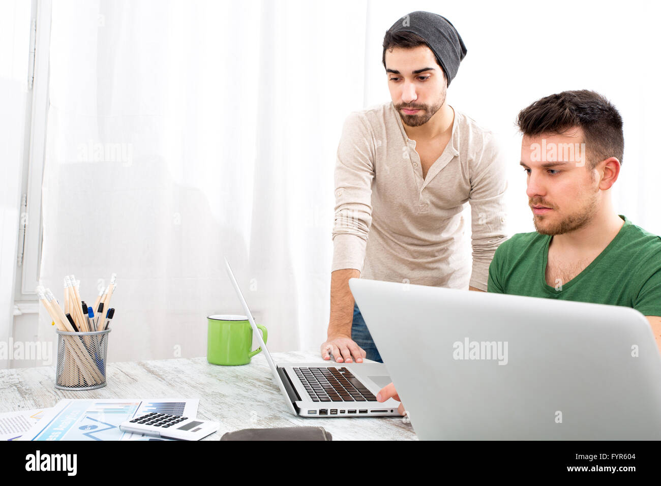 Friends working together Stock Photo - Alamy