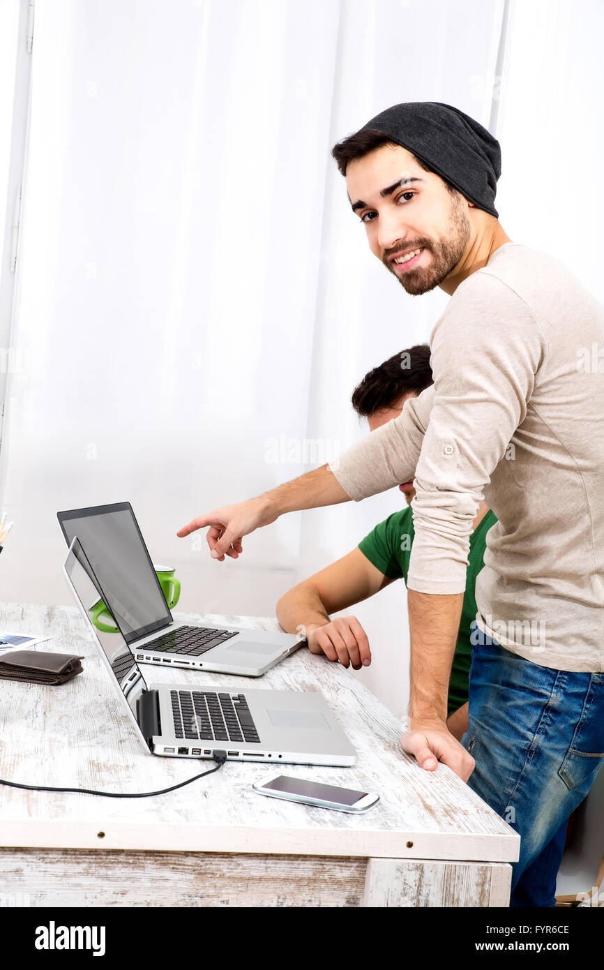 Two co-workers discussing something in the office Stock Photo - Alamy