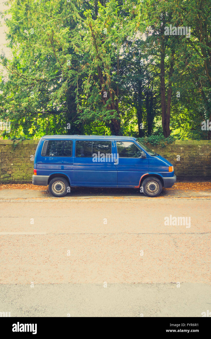 blue minibus at the side of the road Stock Photo - Alamy