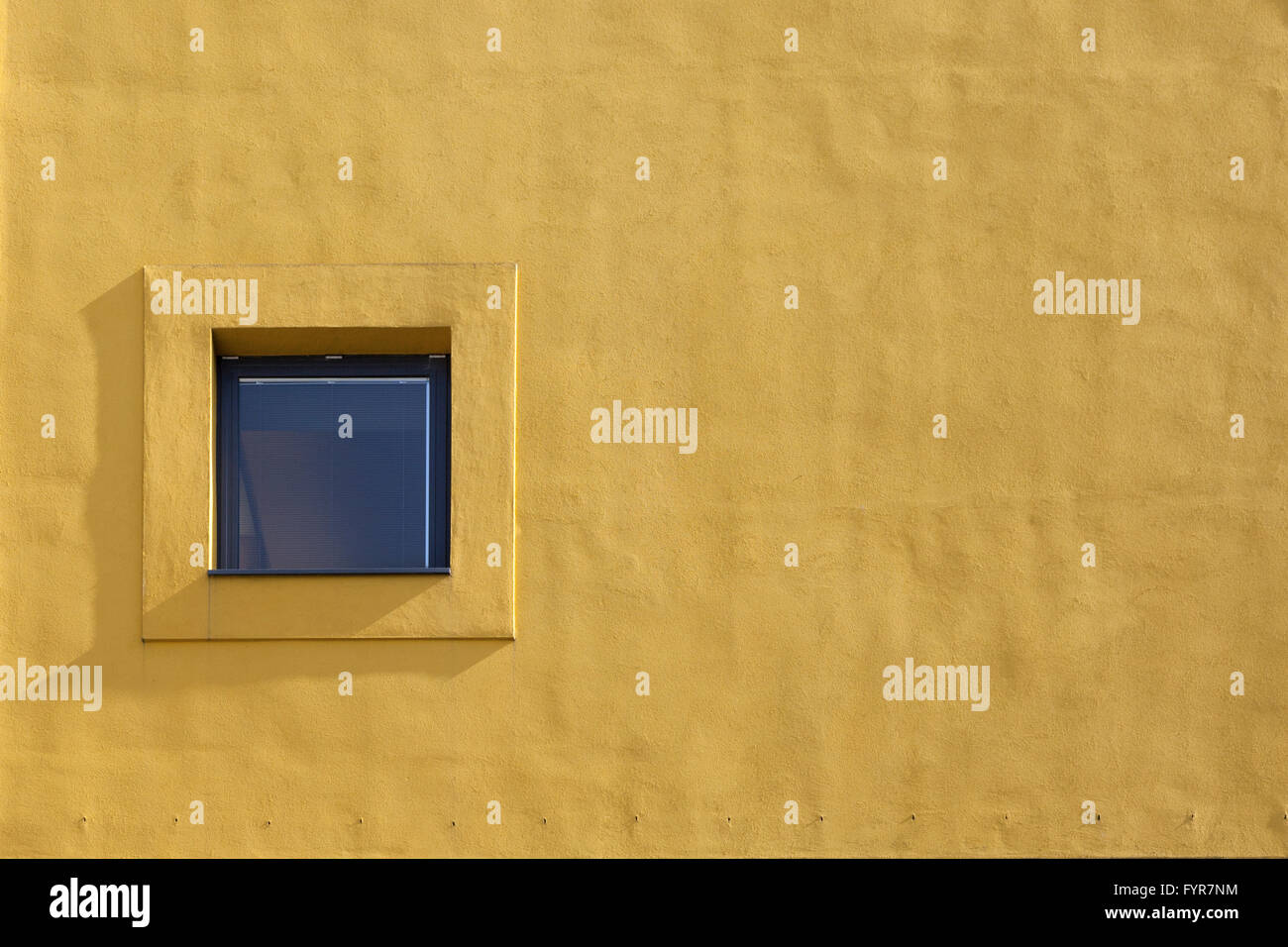 square window in a yellow wall Stock Photo - Alamy