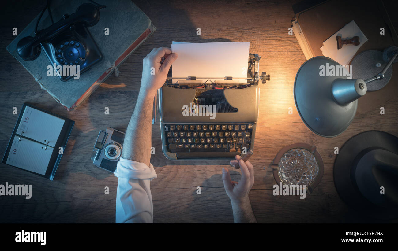 Vintage journalist's desk 1950s style, he is working and typing on his ...