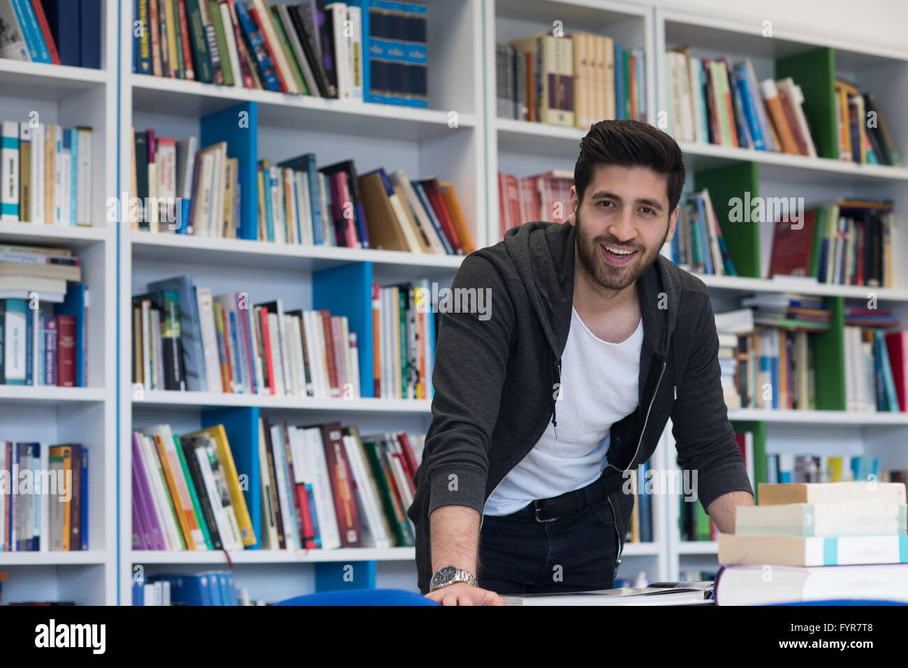 Student reading book in school library. Study lessons for exam. Hard ...