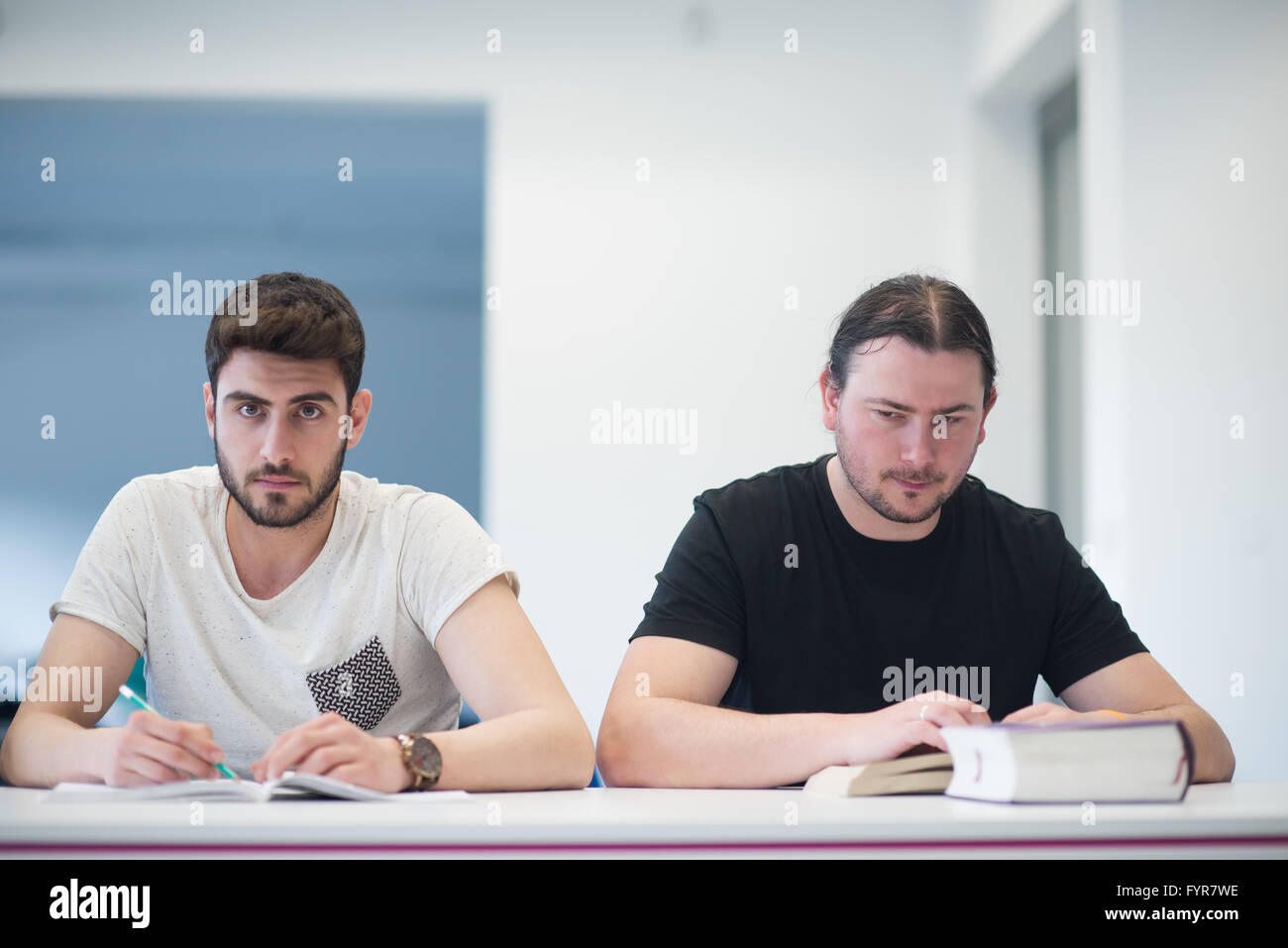 male student in classroom working homework and learning with laptop ...