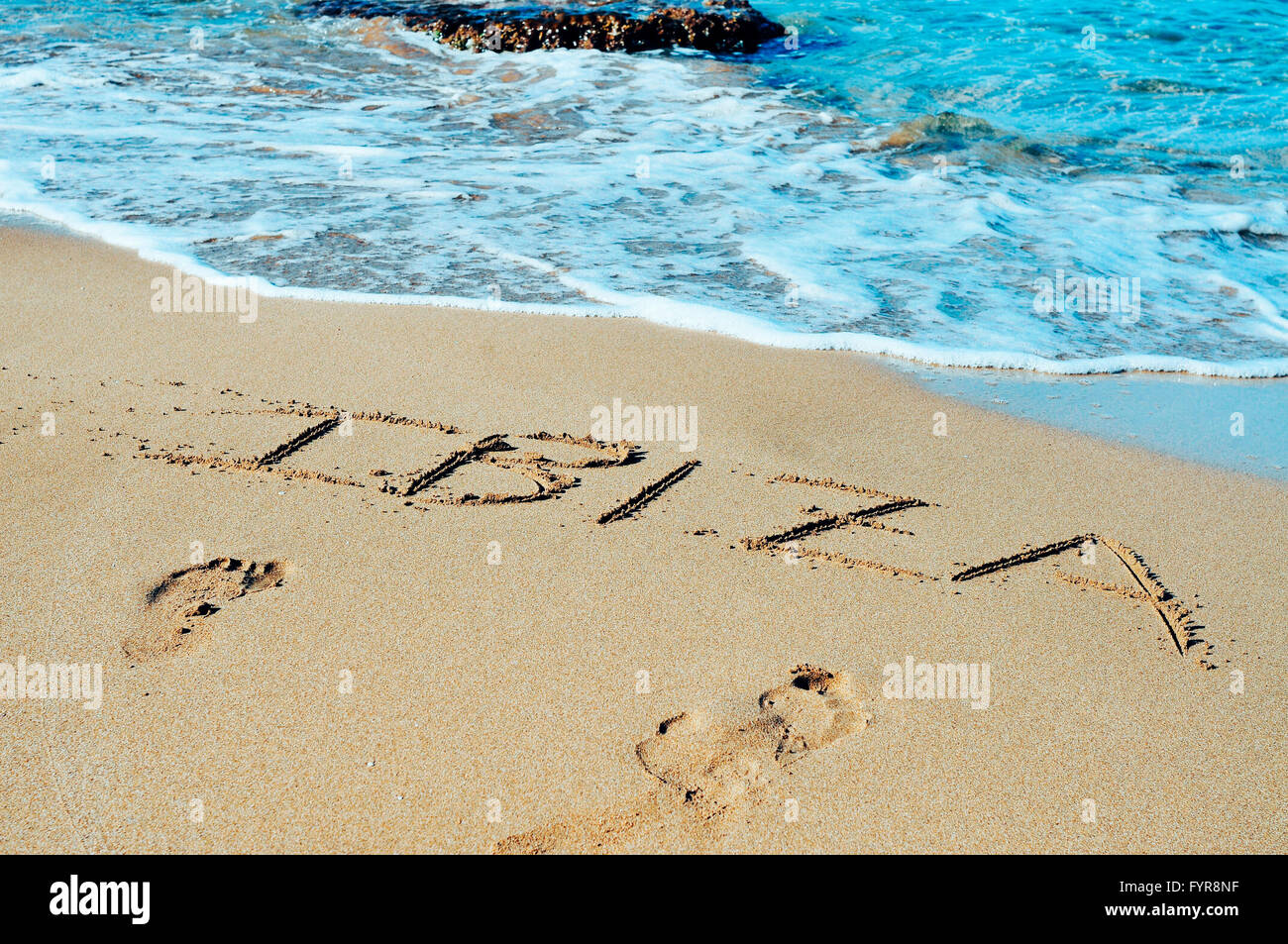 the word Ibiza written in the sand of a beach in Ibiza Island, Balearic ...