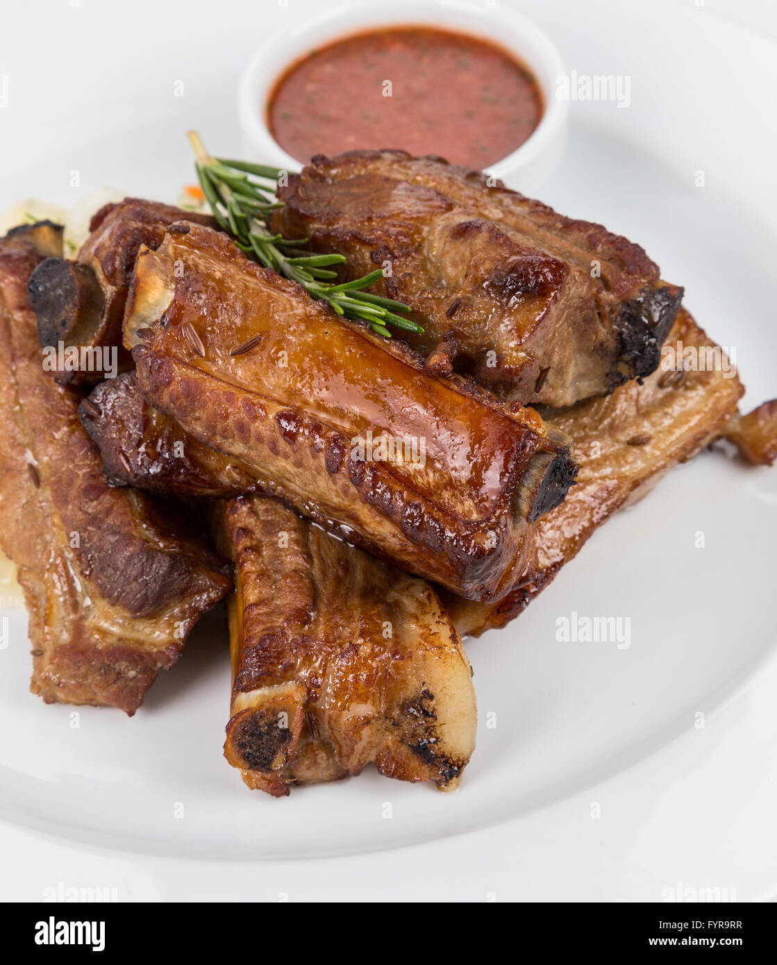 portion hot smoked barbecue ribs on white plate serving in restaurant ...