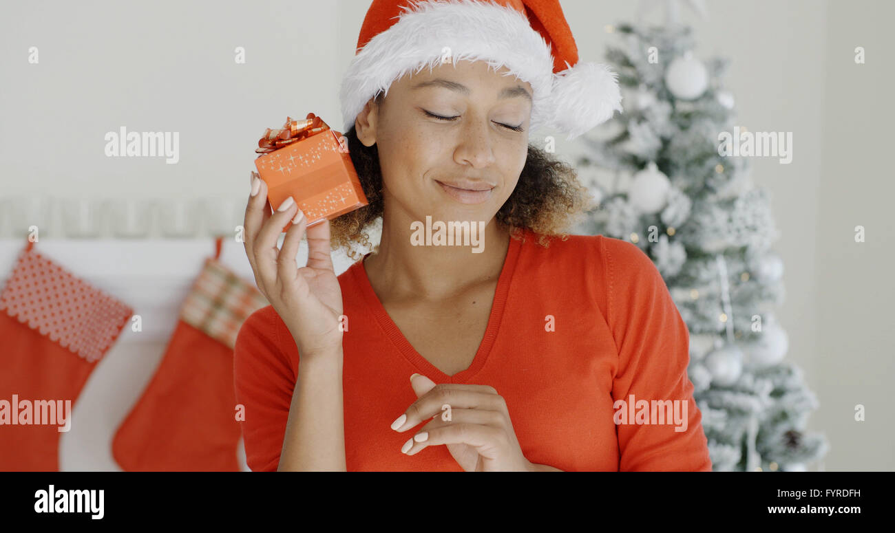 Woman shaking gift box hi-res stock photography and images - Alamy