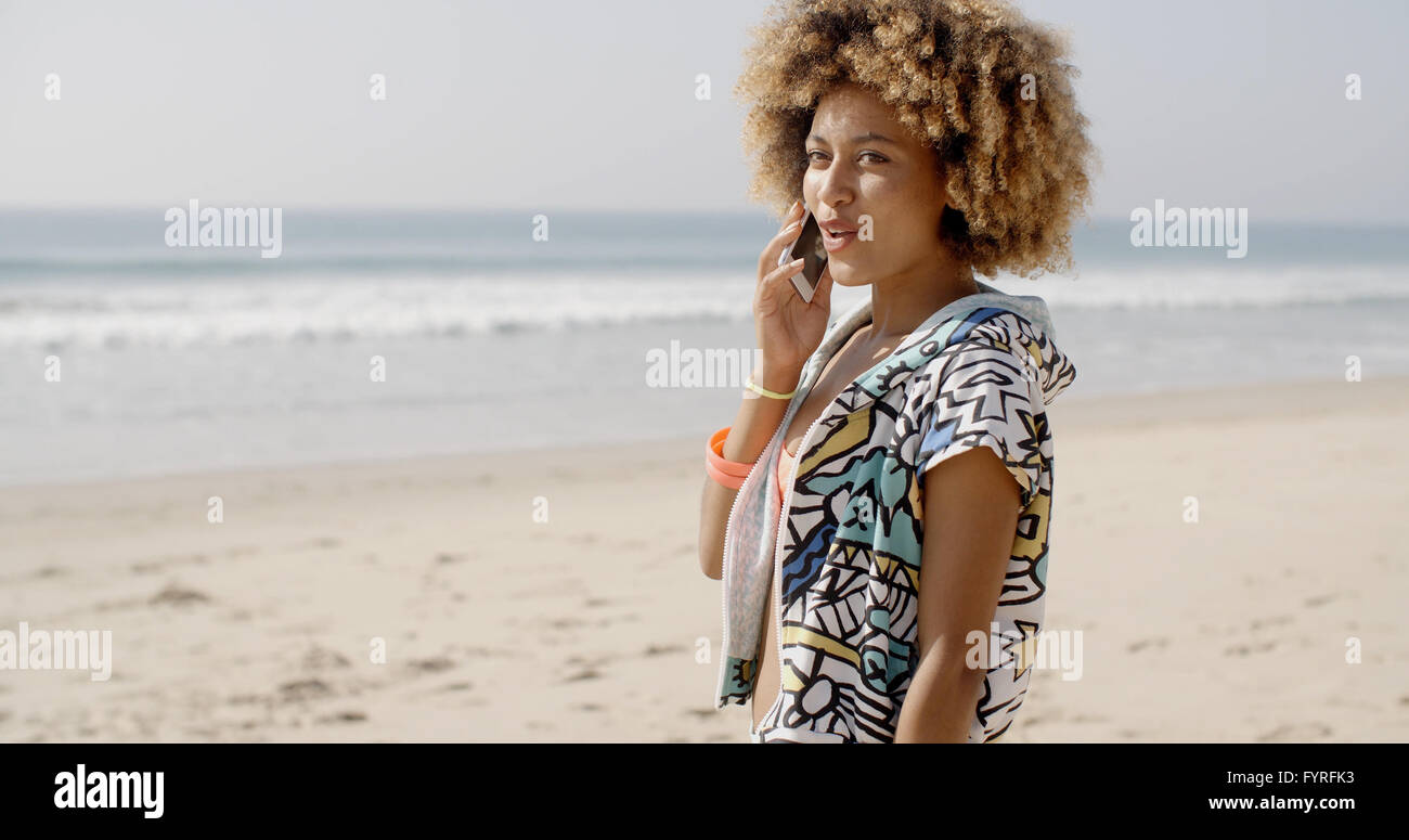 On the beach with phone hi-res stock photography and images - Alamy