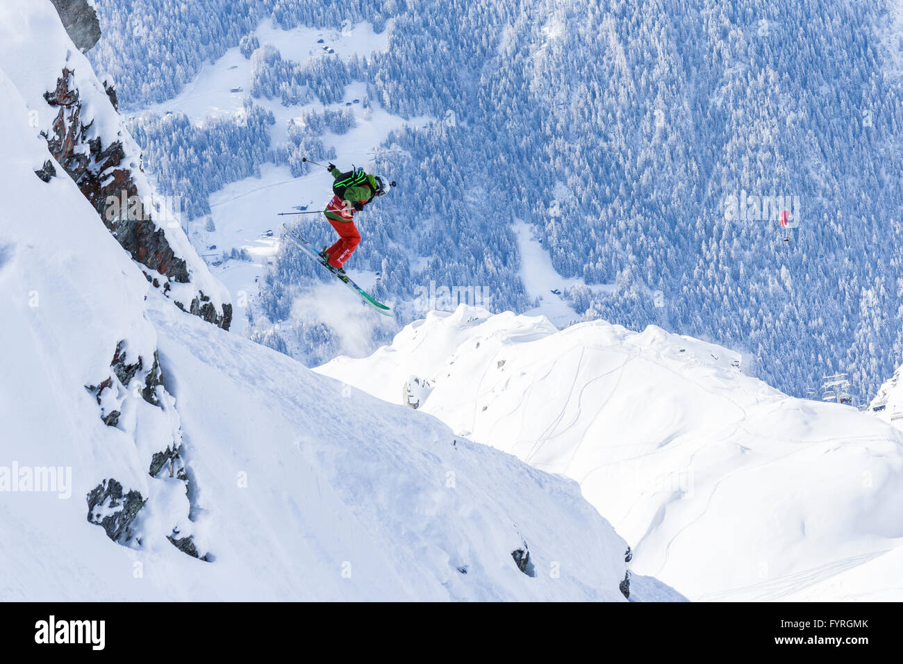 Skier jumping off a cliff in the powder Stock Photo - Alamy