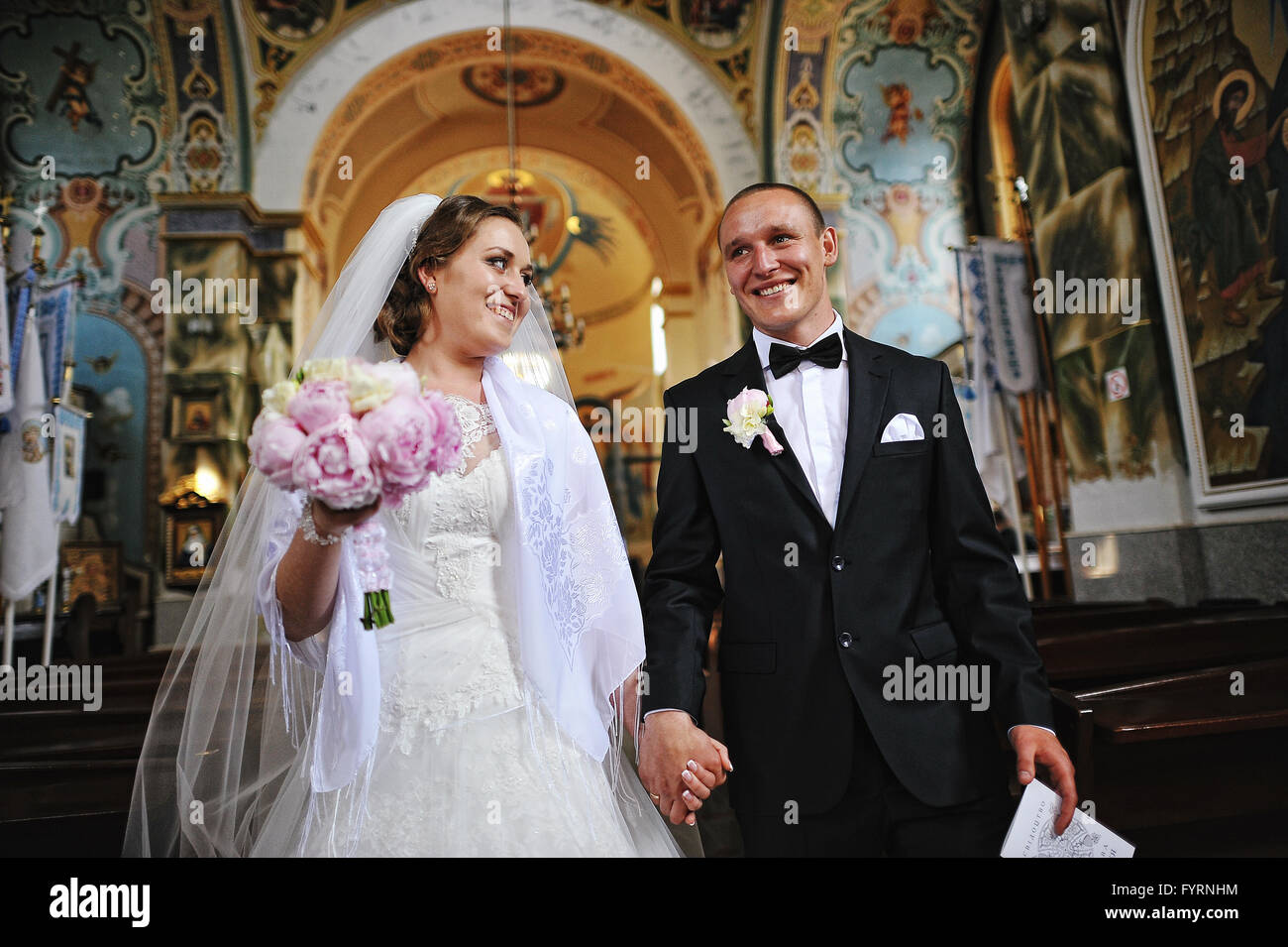 Happy wedding couple at church Stock Photo - Alamy