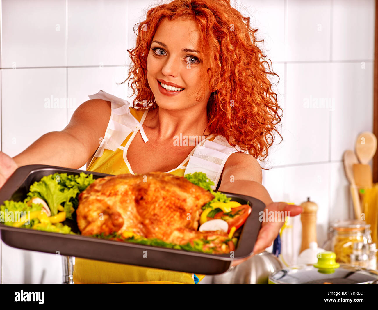 Woman cooking chicken at kitchen Stock Photo - Alamy
