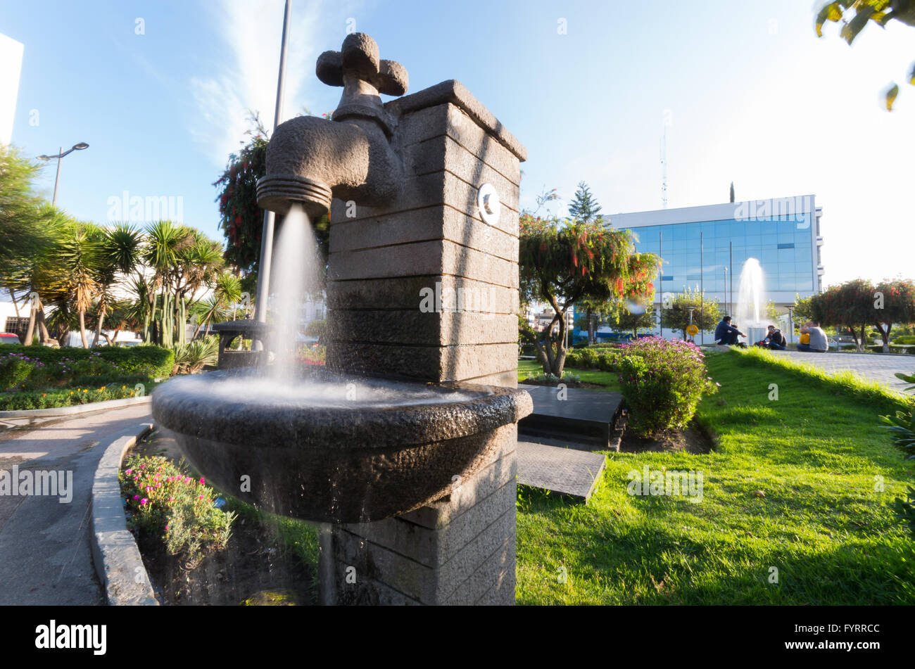 Water flowing from big faucet decorating the garden from a building ...