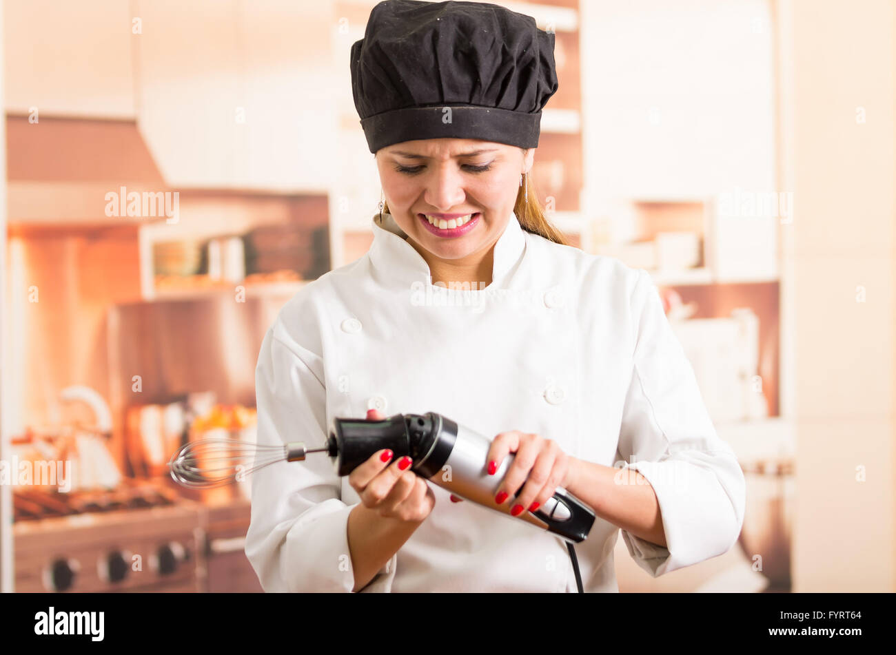 Woman chef holding a broken electric blender with unsatisfied facial ...
