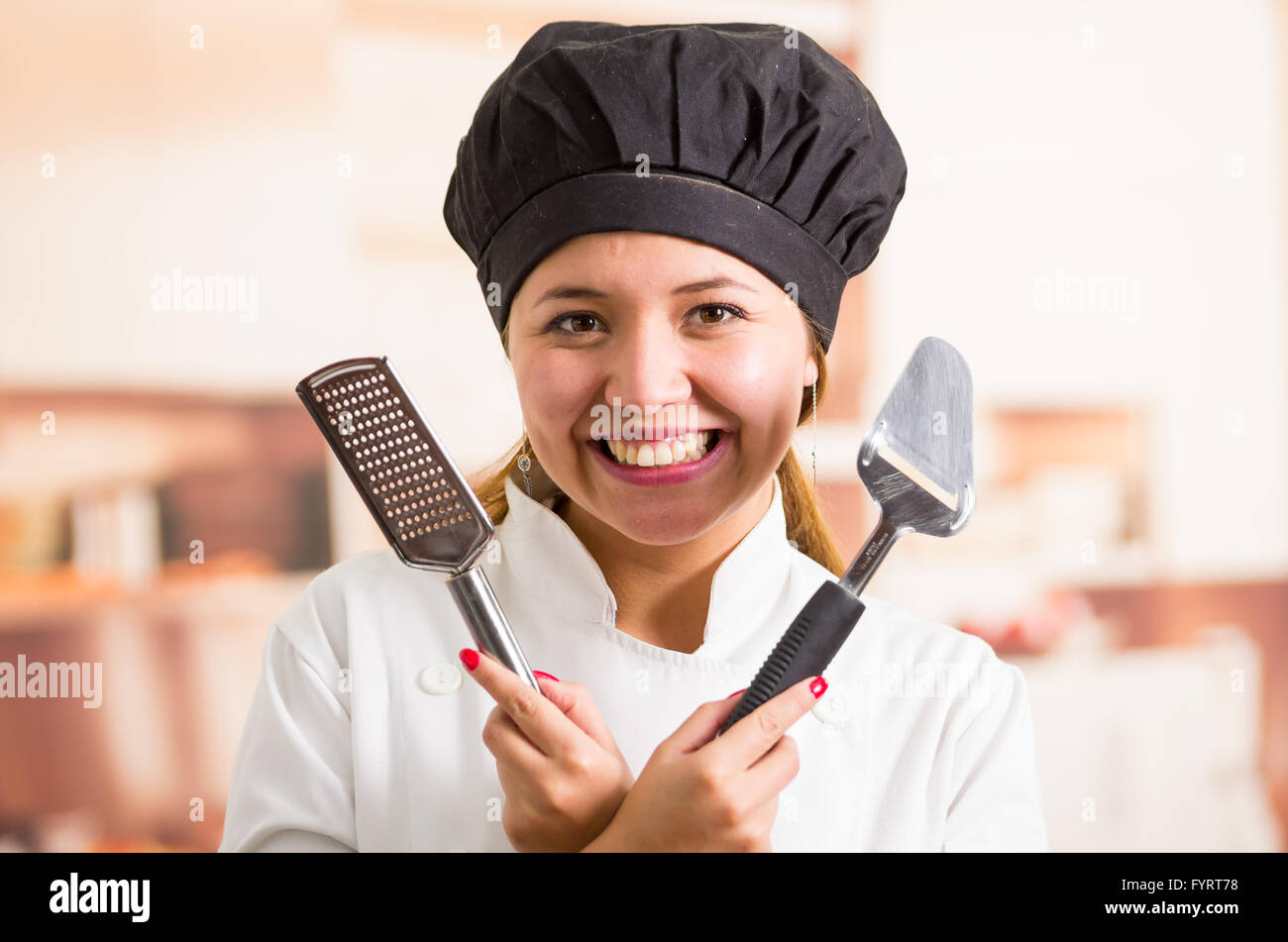 Woman chef wearing cooking outfit posing happily holding up cheese ...