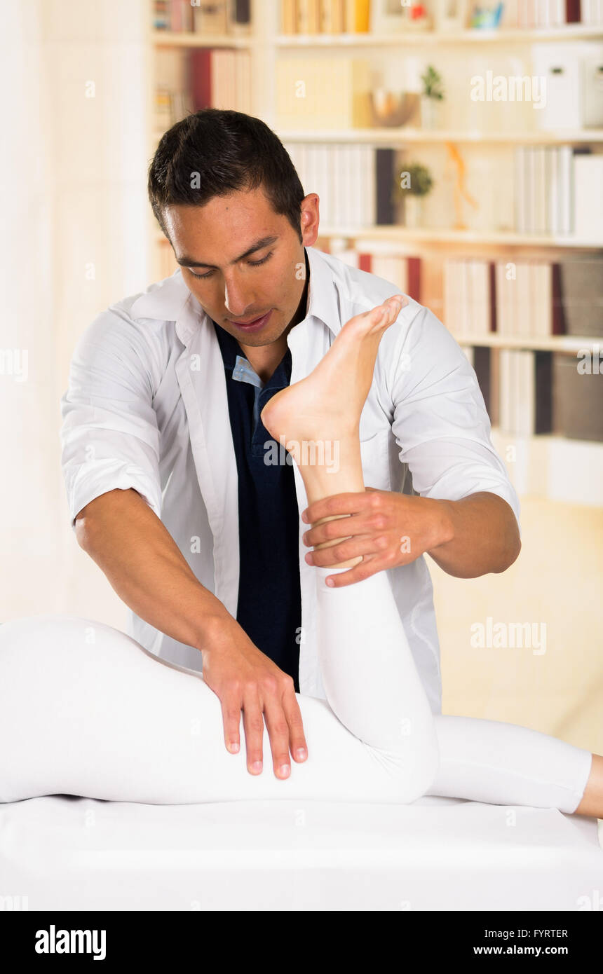 Male Physio Therapist Hands Working On Female Patients Legs Holding